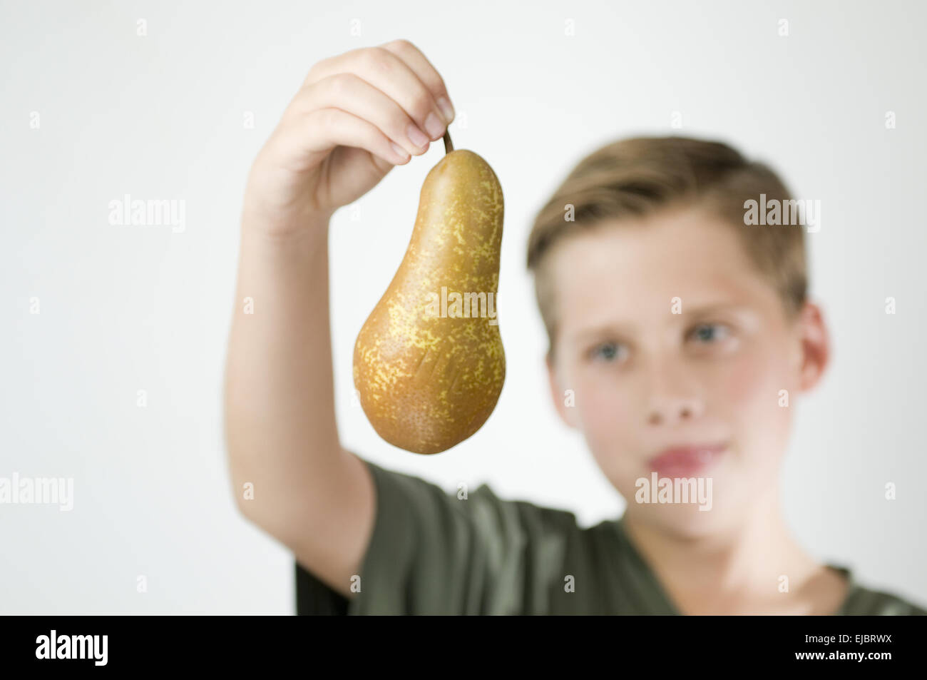 Boy holding a delicious pear Stock Photo - Alamy