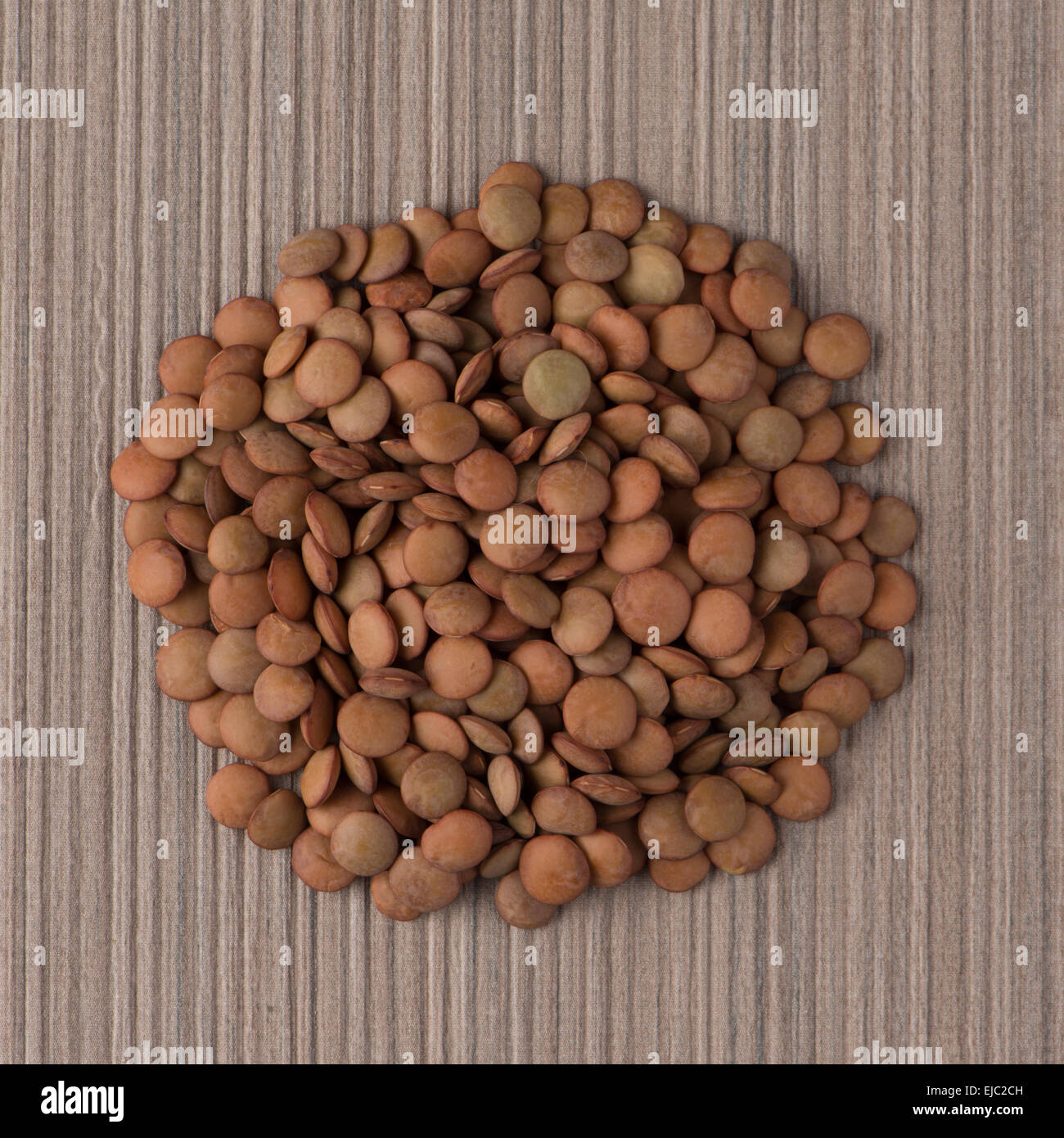 Top view of circle of lentils against brown vinyl background Stock ...
