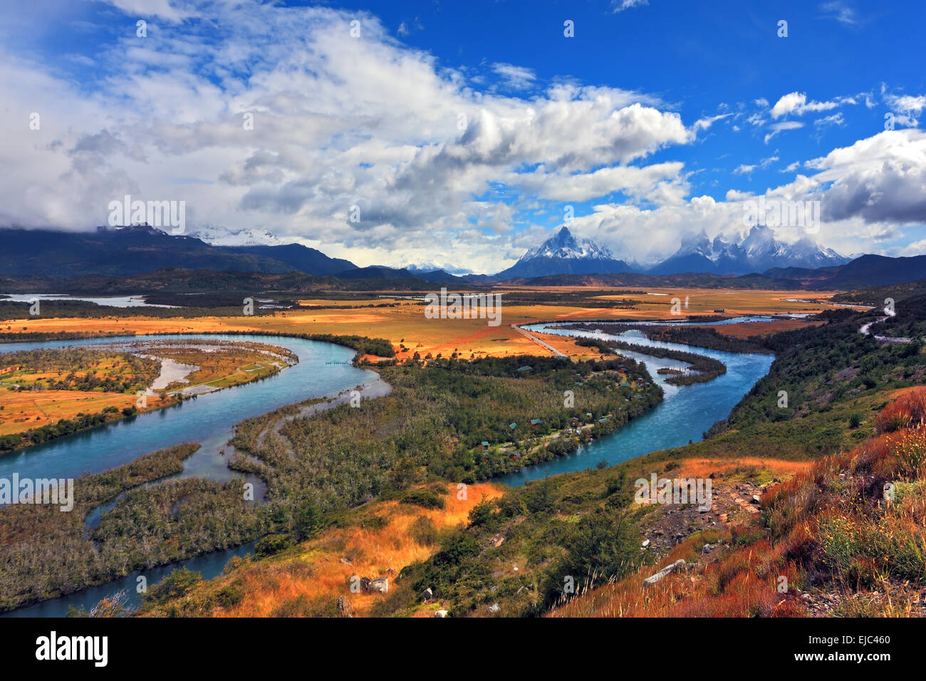 Valley surrounded by snow-capped mountains Stock Photo - Alamy