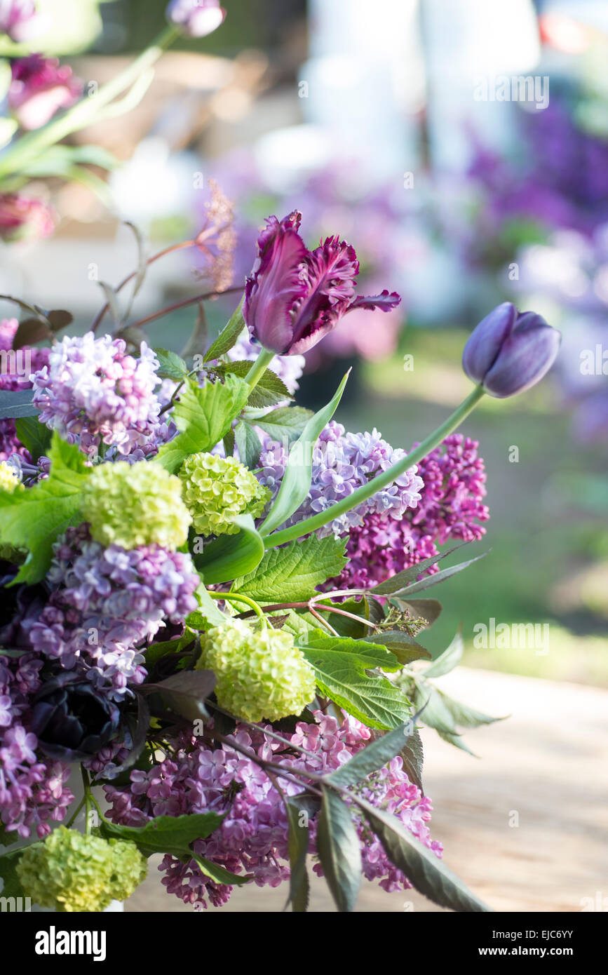 Spring floral bouquet with lilacs, tulips, Snowball bush, hellebore and ...