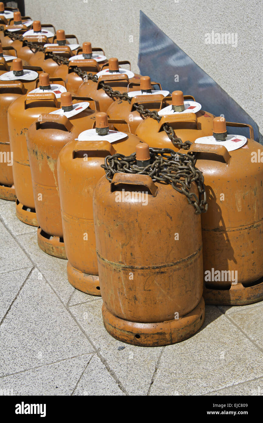 Orange butane cylinders with chains and gas industry abroad Stock Photo ...