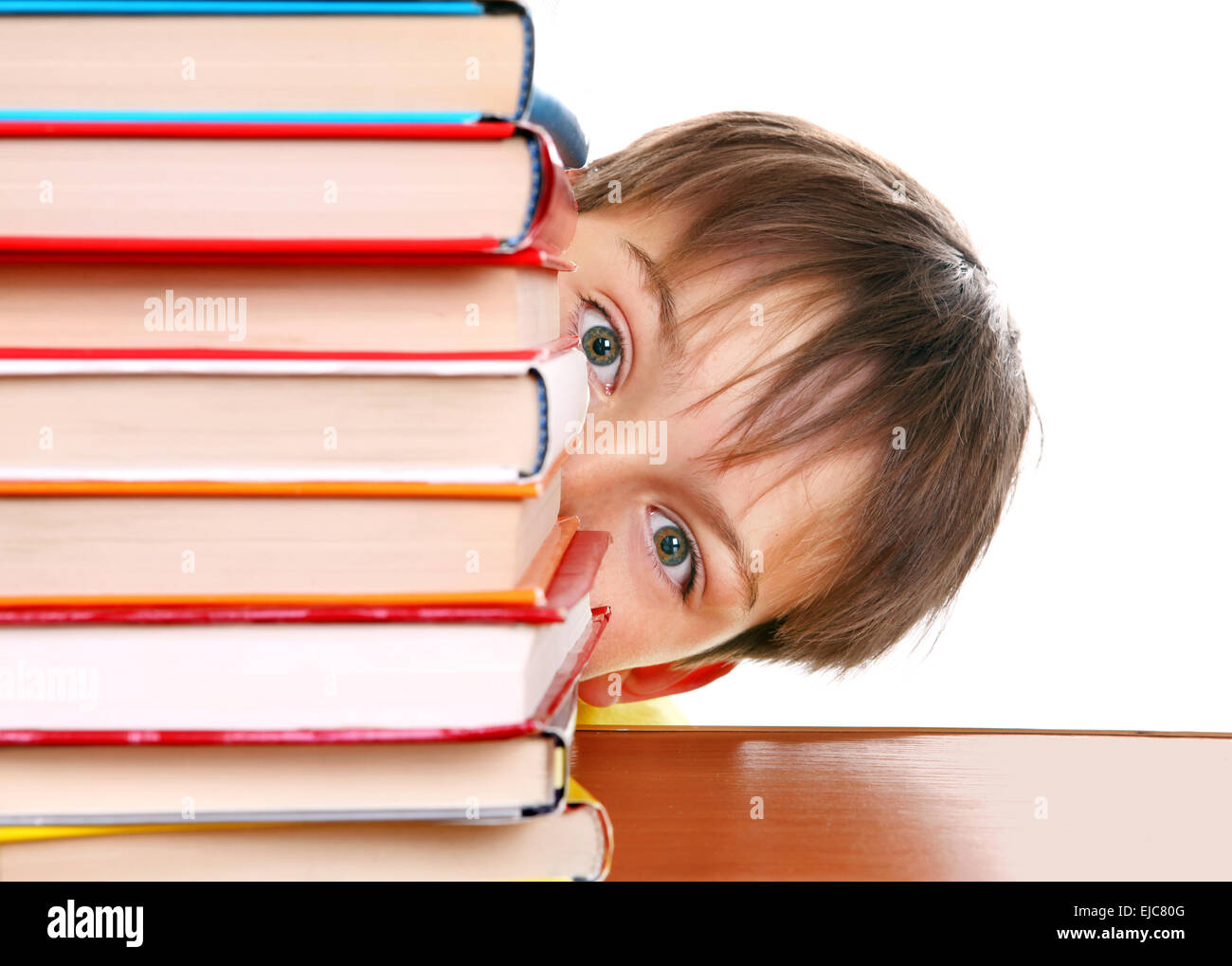 Surprised Kid behind the Books Stock Photo - Alamy