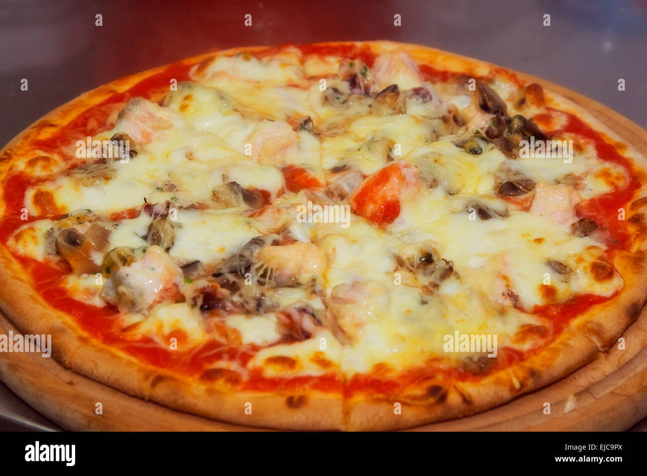 freshly cooked pizza with seafood Stock Photo - Alamy