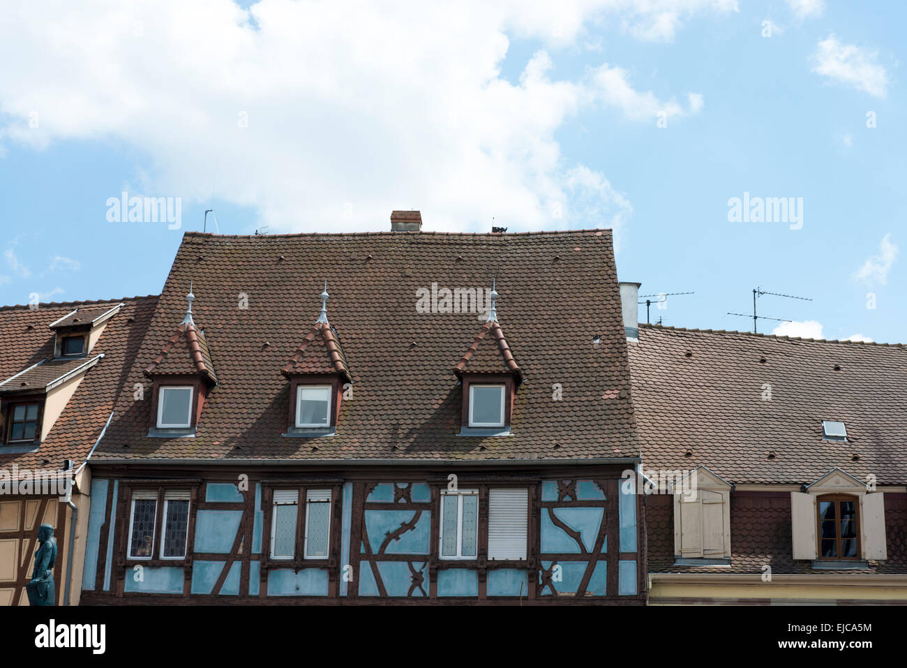 Blue half-timbered medieval building with stained glass window, Colmar ...