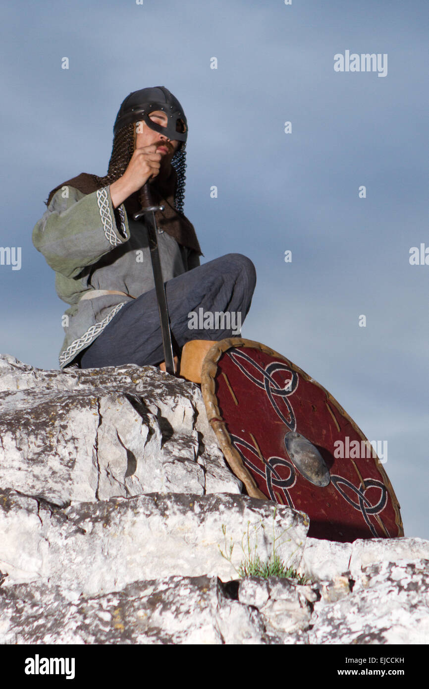 Knight sitting on a rock Stock Photo - Alamy