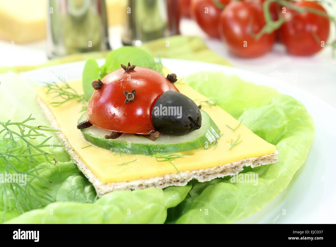 Crispbread with cheese and ladybug Stock Photo - Alamy