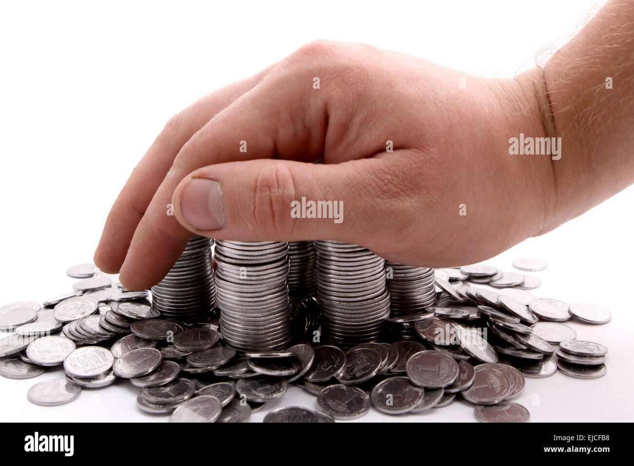 Hand adding coins Stock Photo - Alamy