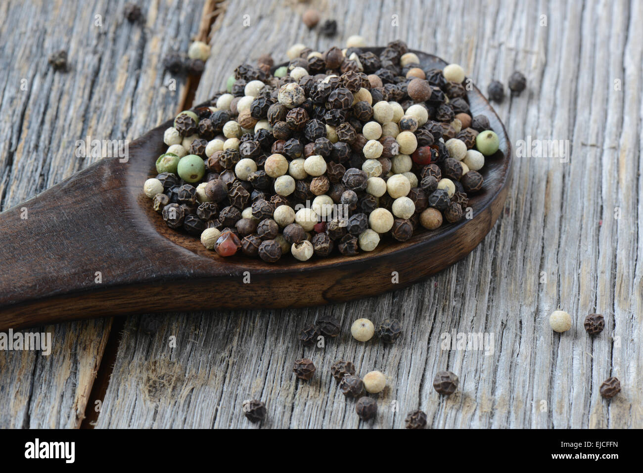 White peppercorn on wooden spoon hi-res stock photography and images ...