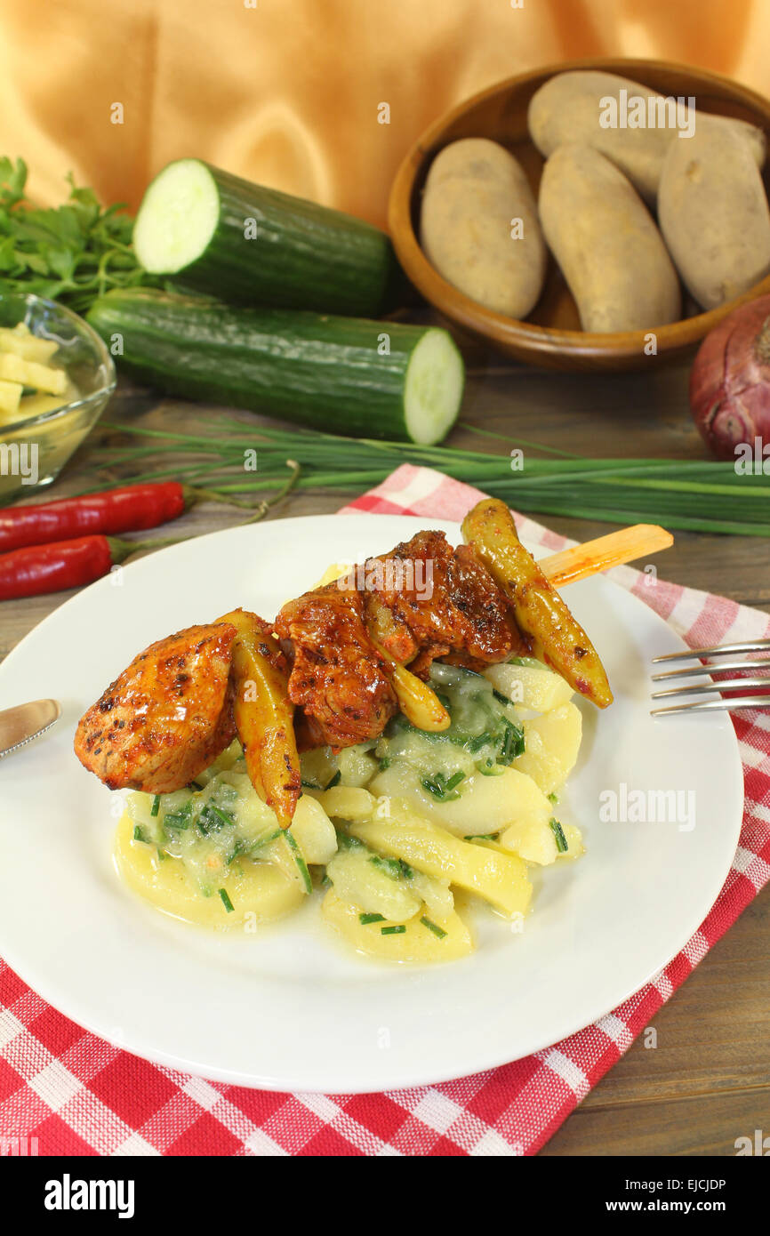 Potato-cucumber salad with fire skewers Stock Photo - Alamy