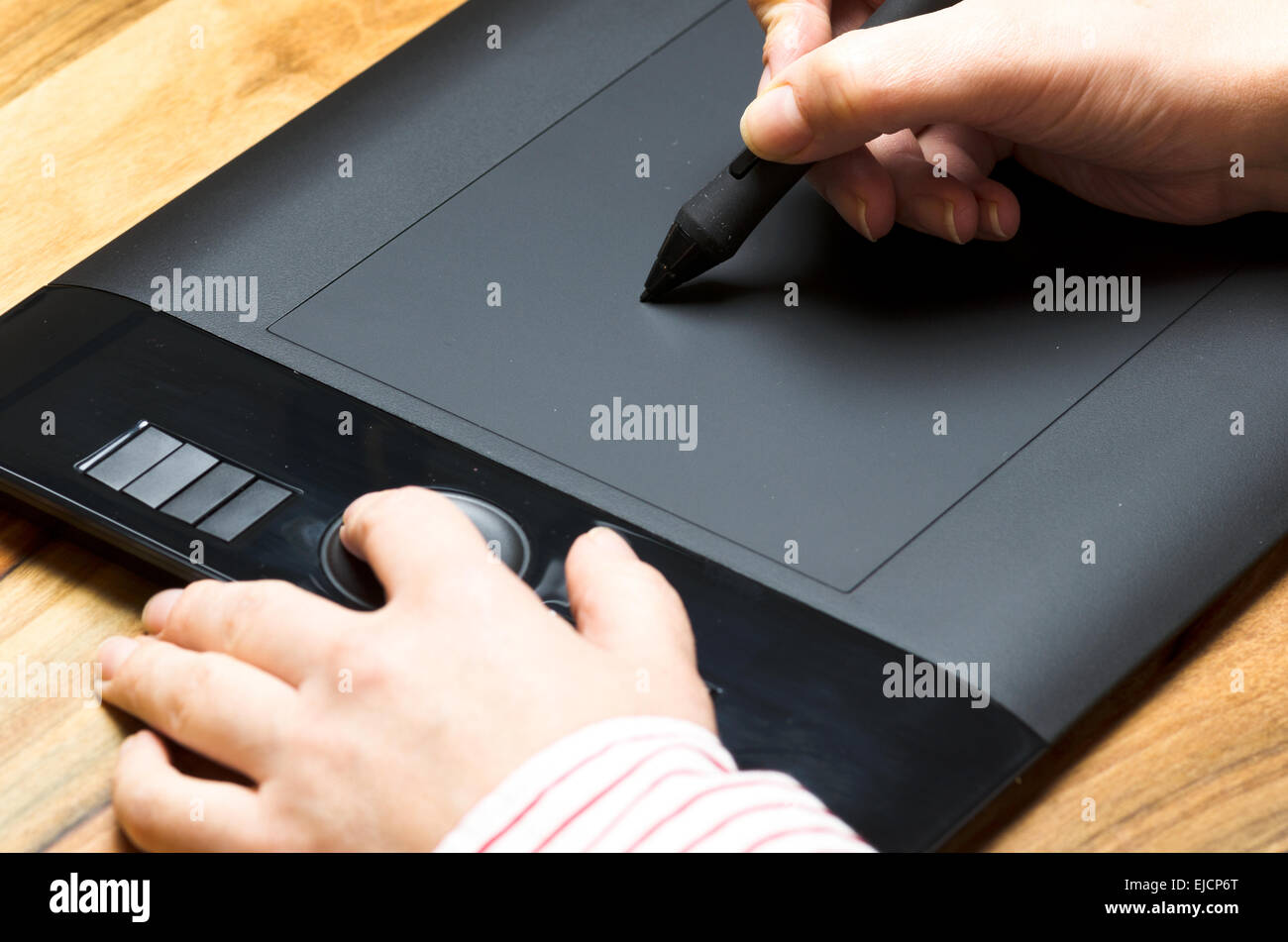 Hands with graphics tablet Stock Photo - Alamy