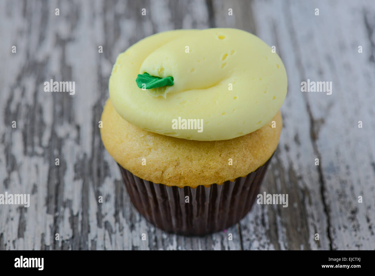 Lemon Cupcake on Wood Background Stock Photo - Alamy