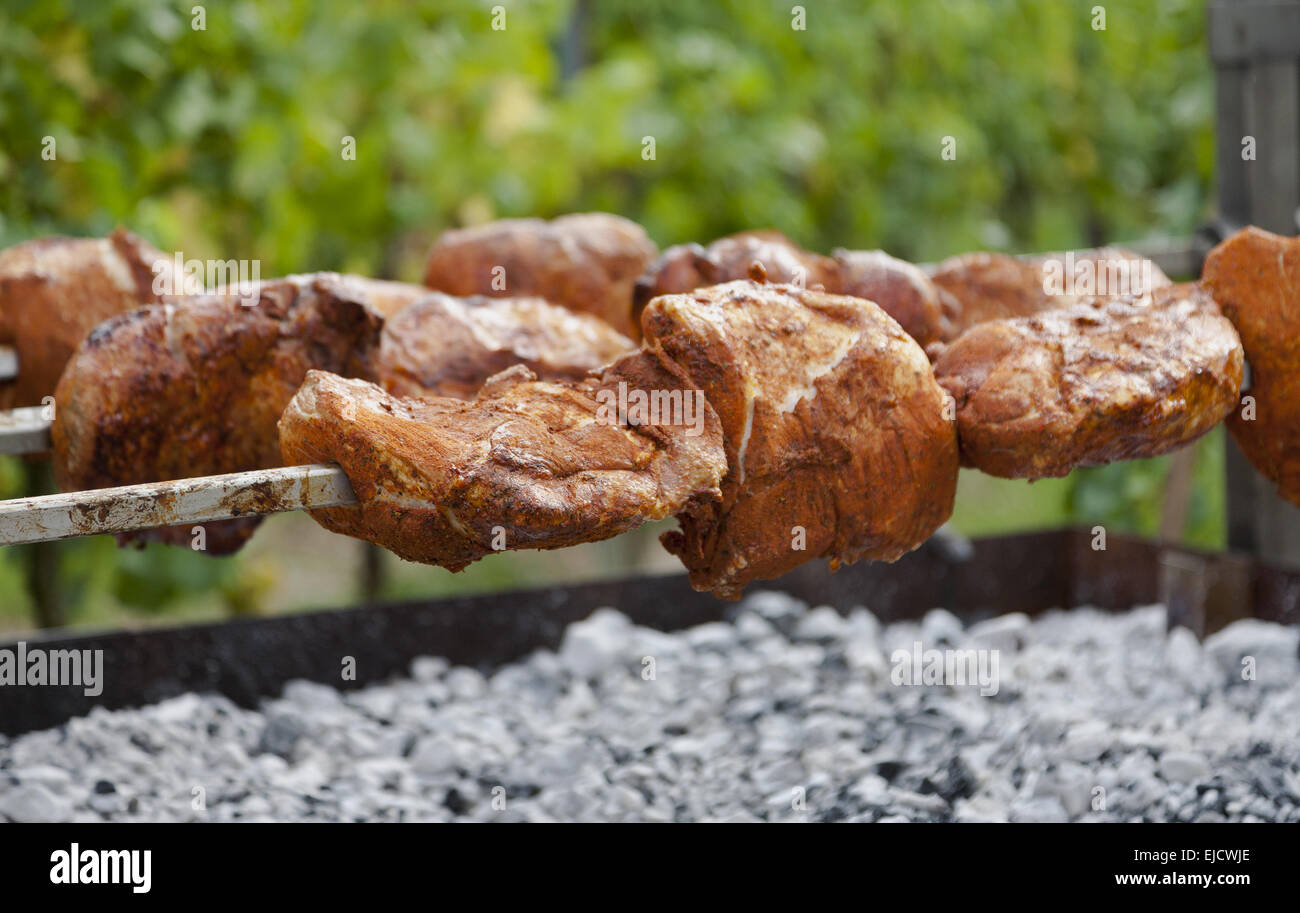 Meat spits on the grill Stock Photo - Alamy