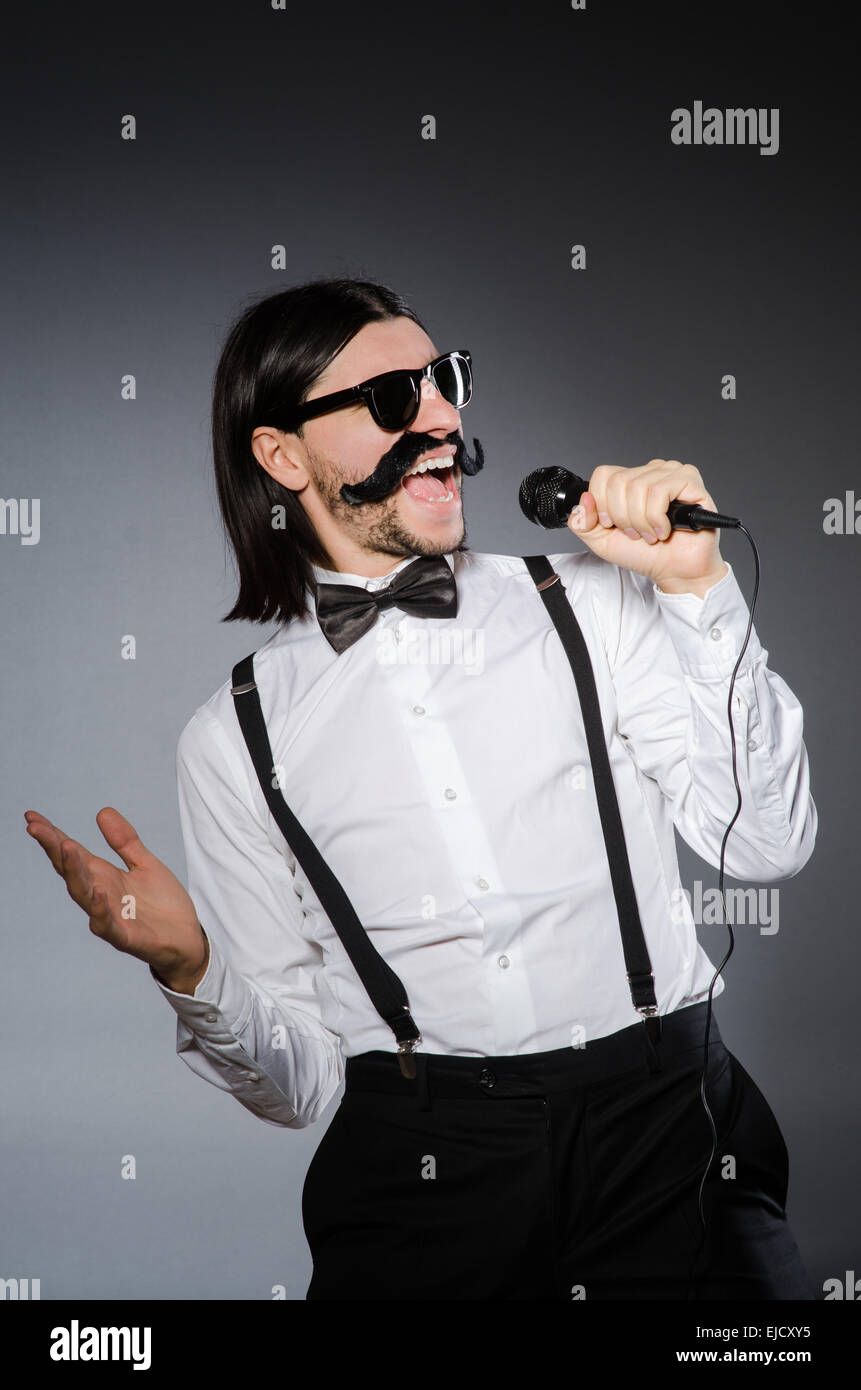 Funny singer with microphone at the concert Stock Photo - Alamy