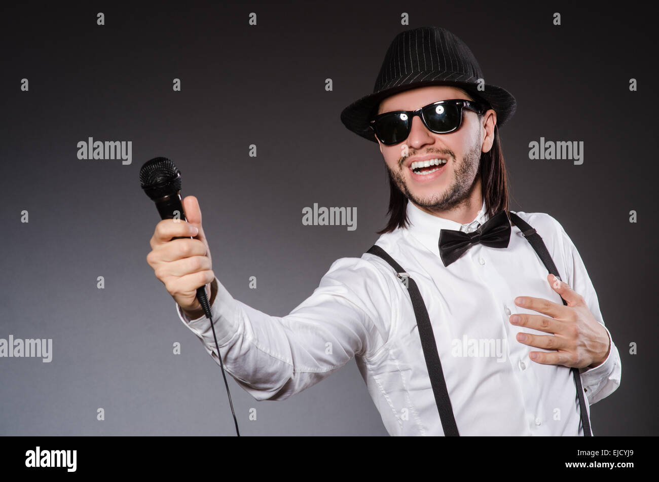 Funny singer with microphone at the concert Stock Photo - Alamy