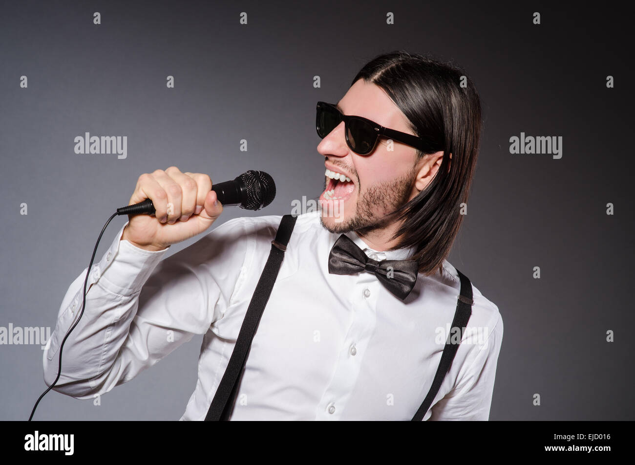 Funny singer with microphone at the concert Stock Photo - Alamy