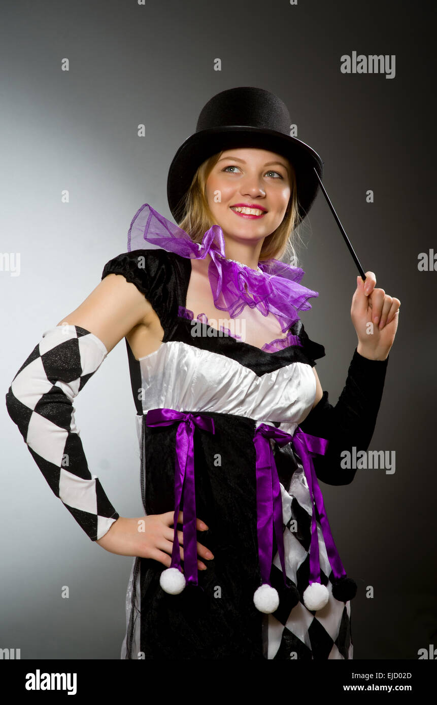 Woman magician doing her tricks with wand Stock Photo - Alamy