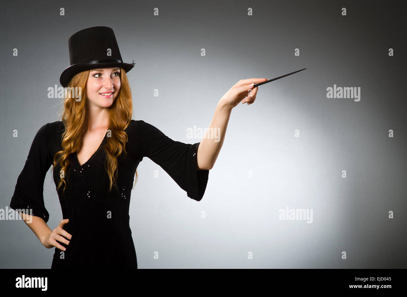 Woman magician doing her tricks with wand Stock Photo - Alamy