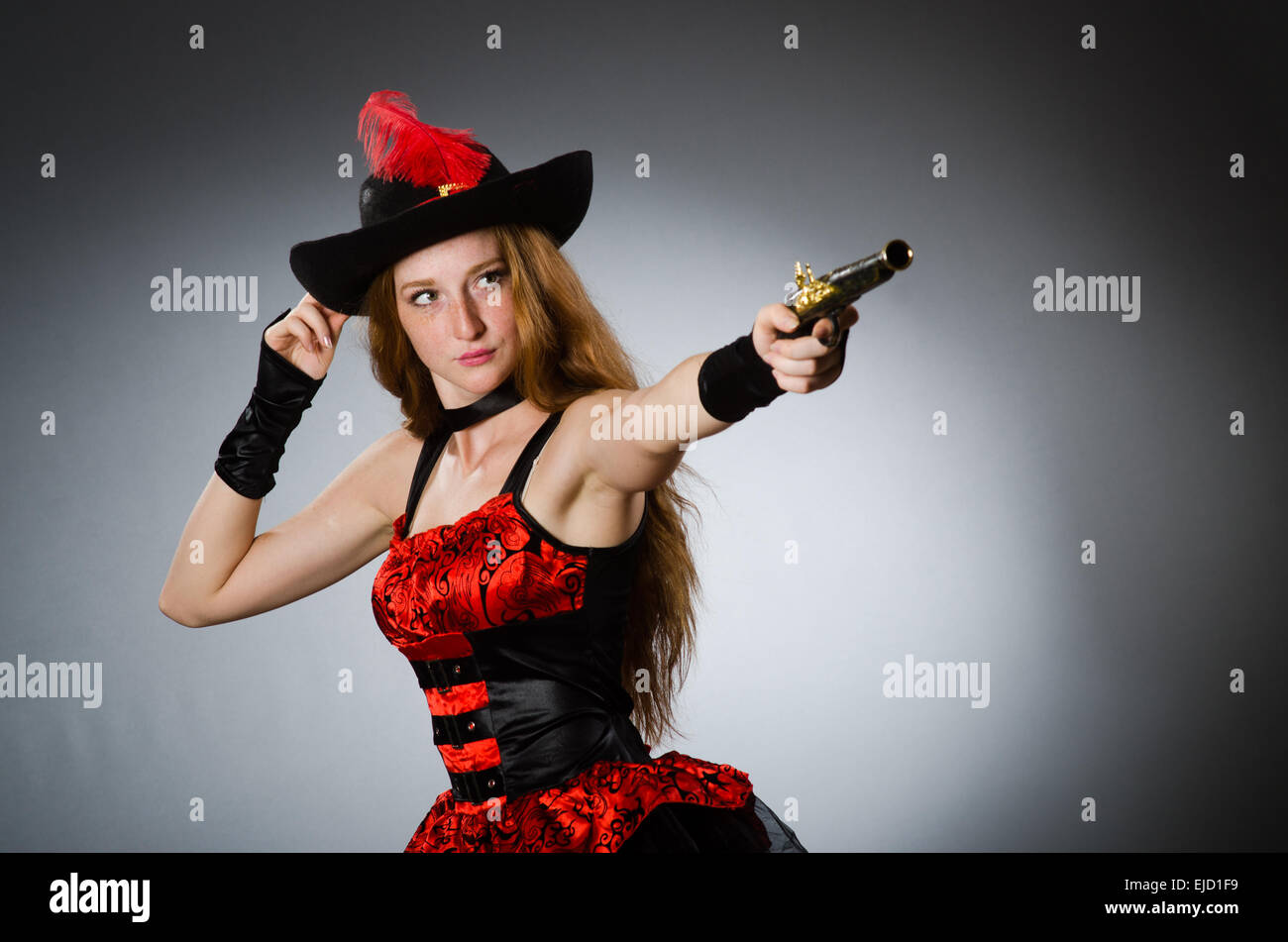 Pirate with gun against grey background Stock Photo - Alamy