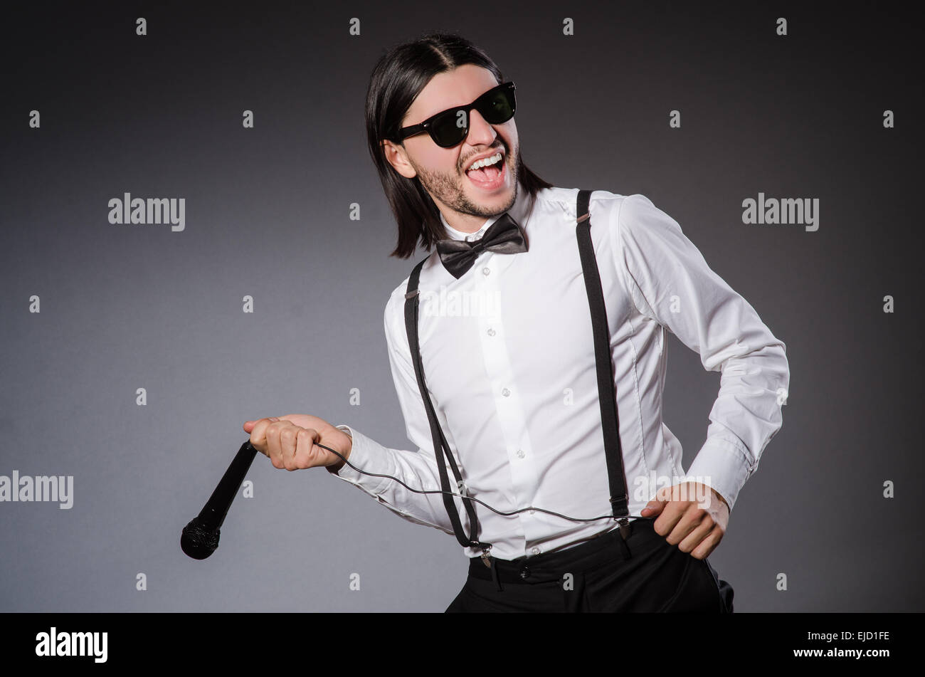 Funny singer with microphone at the concert Stock Photo - Alamy