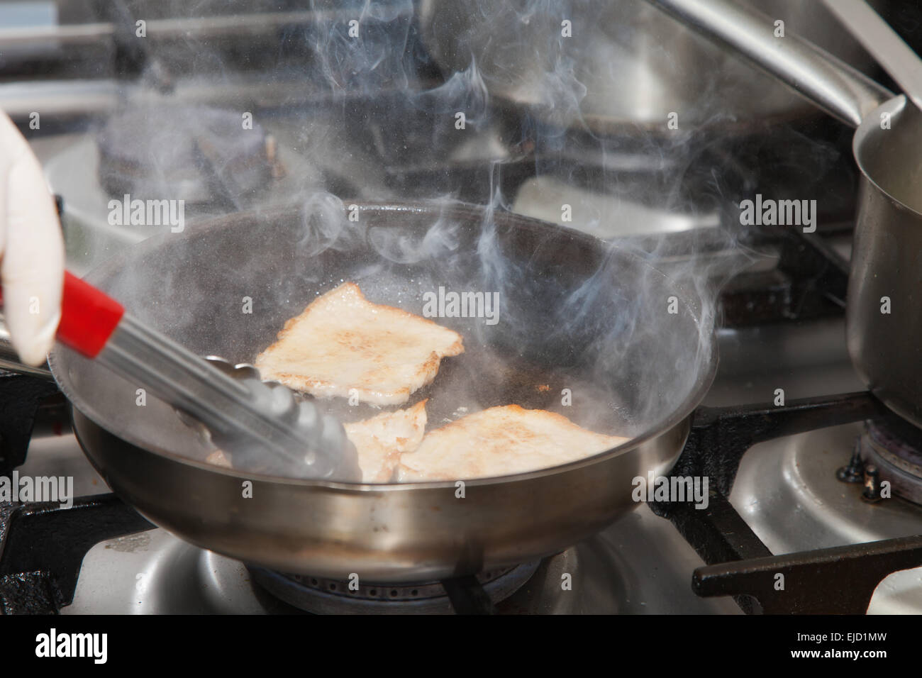 fry the meat in a frying pan Stock Photo - Alamy