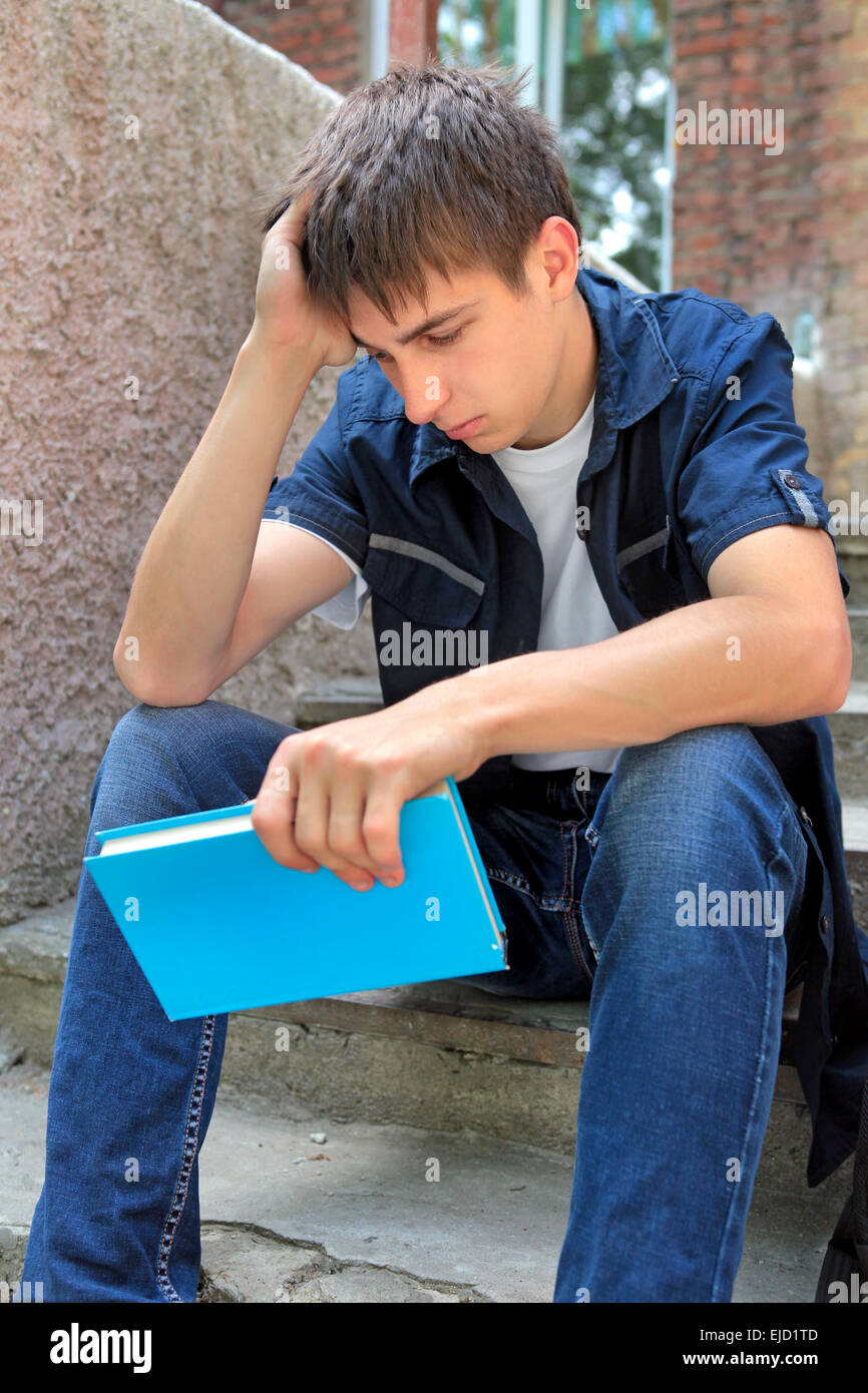 Sad Student with the Book Stock Photo - Alamy