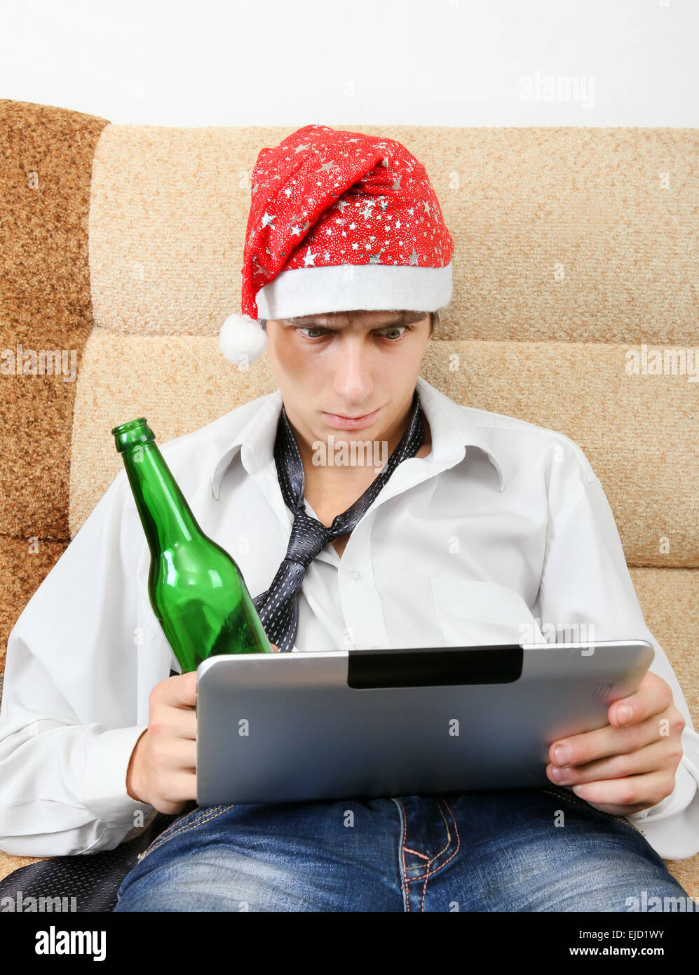 Teenager with a Beer and Tablet Stock Photo - Alamy