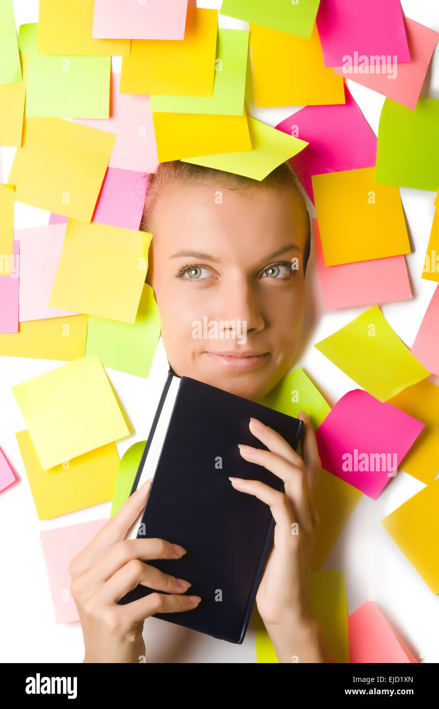 Woman with many reminder notes reading book Stock Photo - Alamy