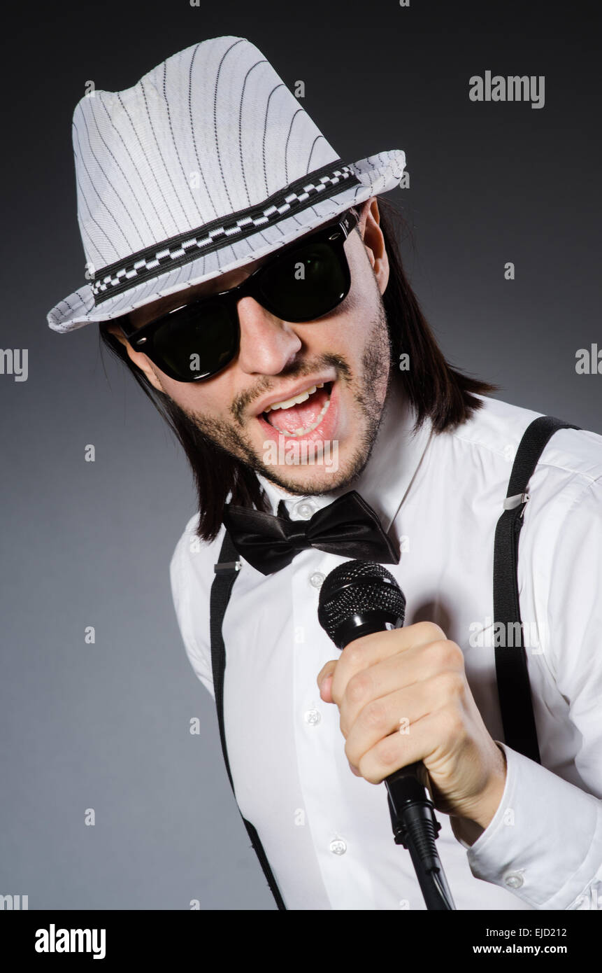 Funny singer with microphone at the concert Stock Photo - Alamy