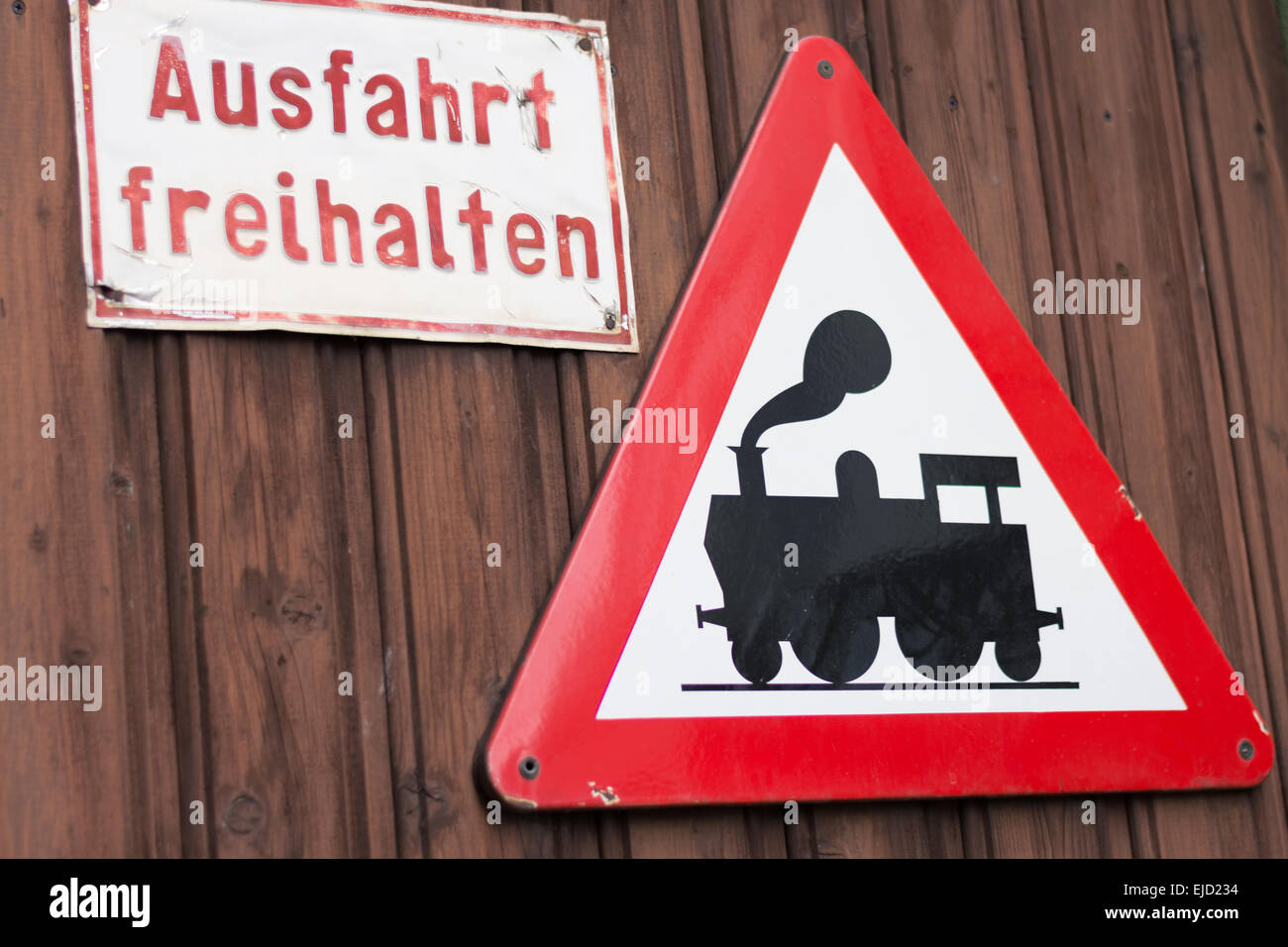 Sign exit combined with attention train Stock Photo - Alamy