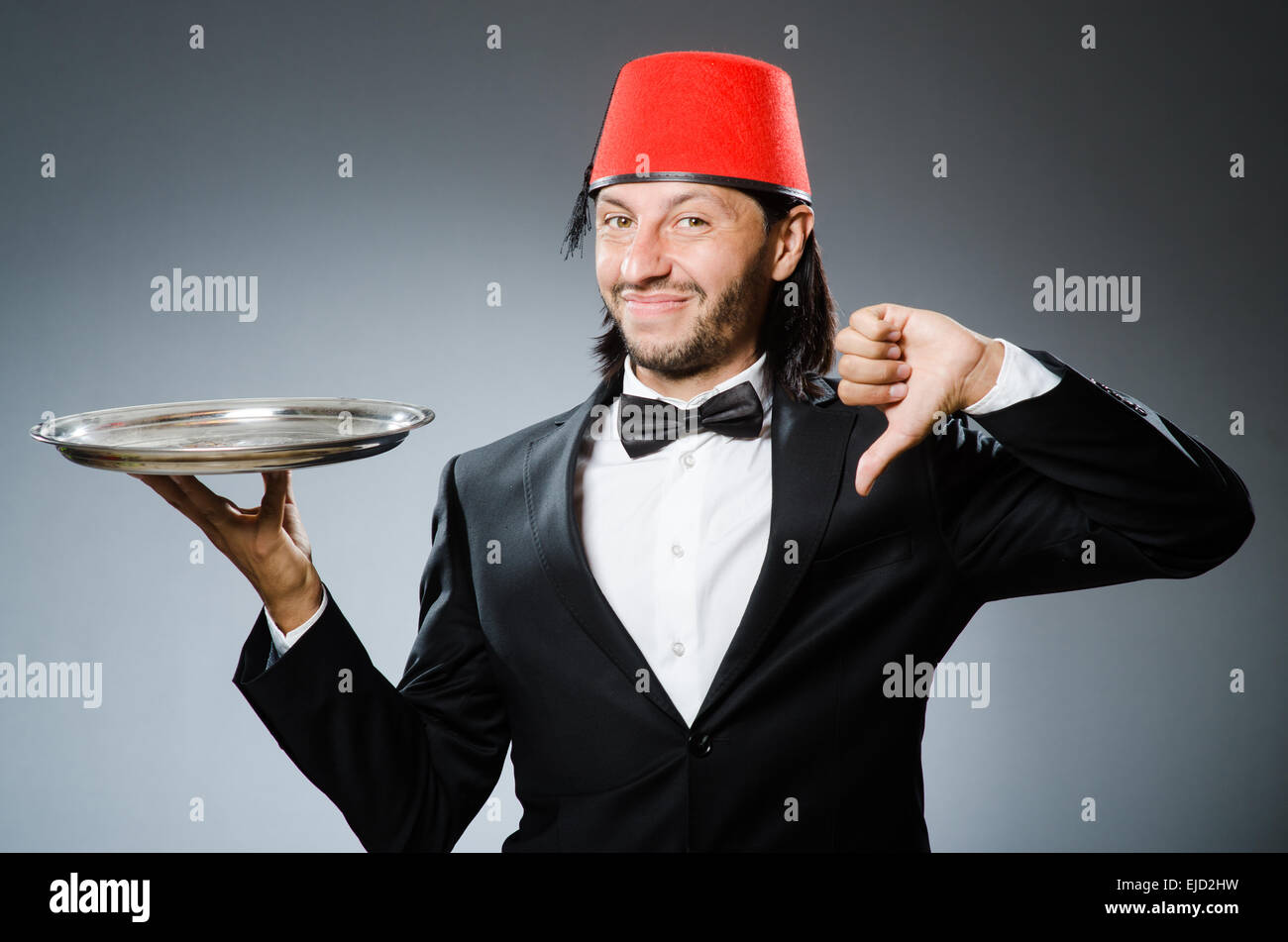 Waiter wearing traditional turkish hat Stock Photo - Alamy
