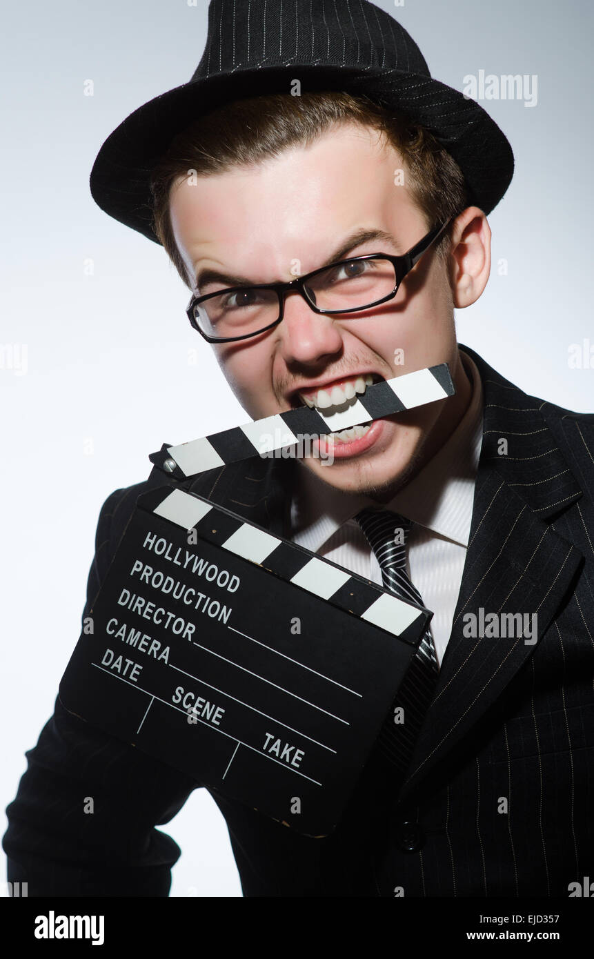 Man with movie clapperboard and hat Stock Photo - Alamy