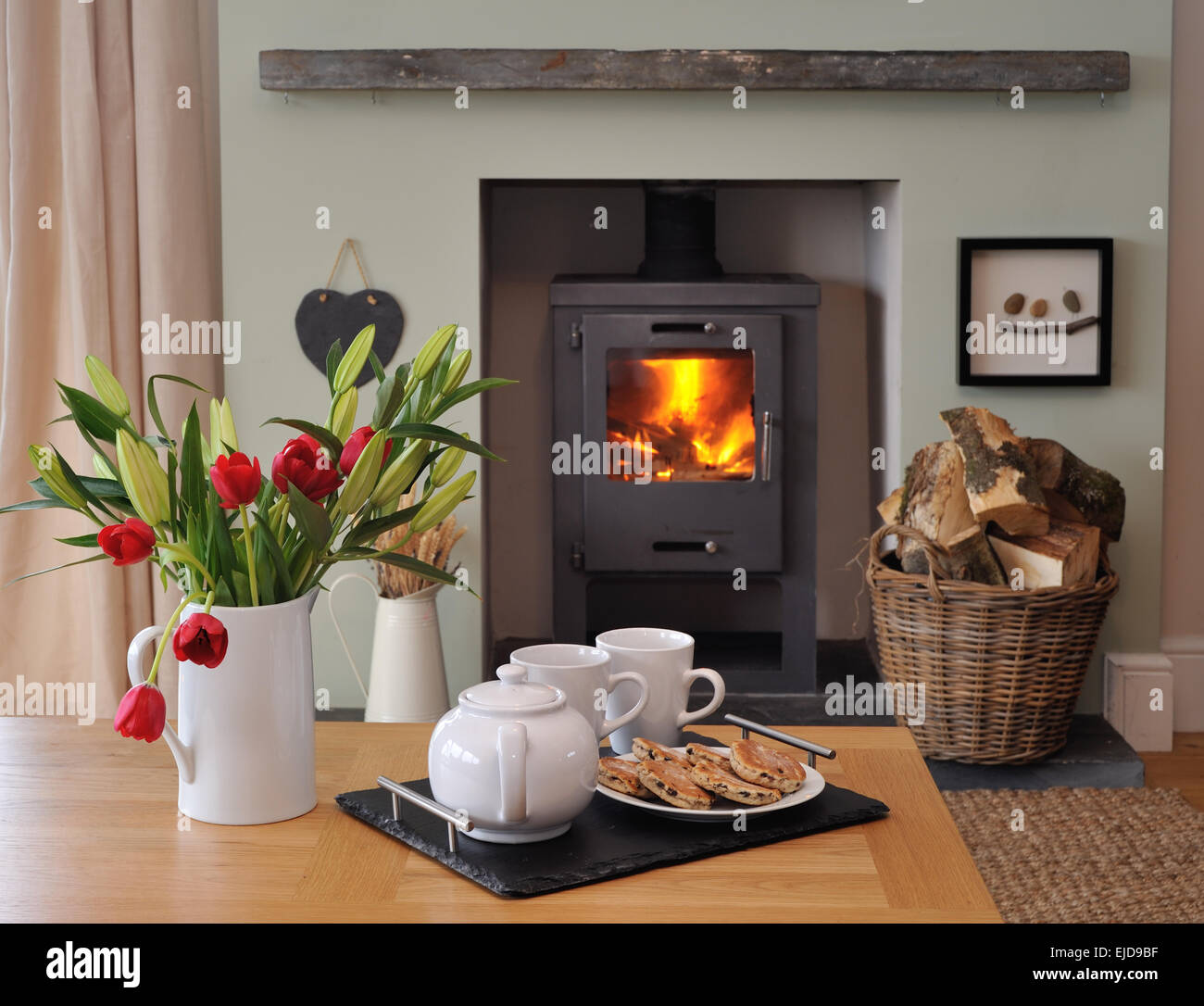 Interior design fireplace with vase of flowers and tea Stock Photo - Alamy