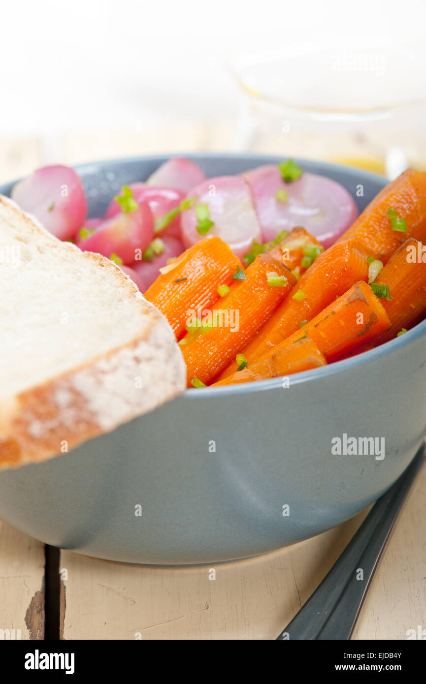 bowl of steamed root vegetable on a rustic white wood table Stock Photo ...