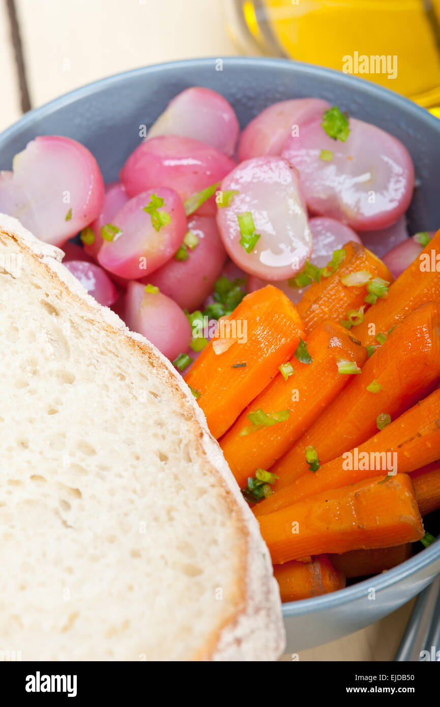 bowl of steamed root vegetable on a rustic white wood table Stock Photo ...
