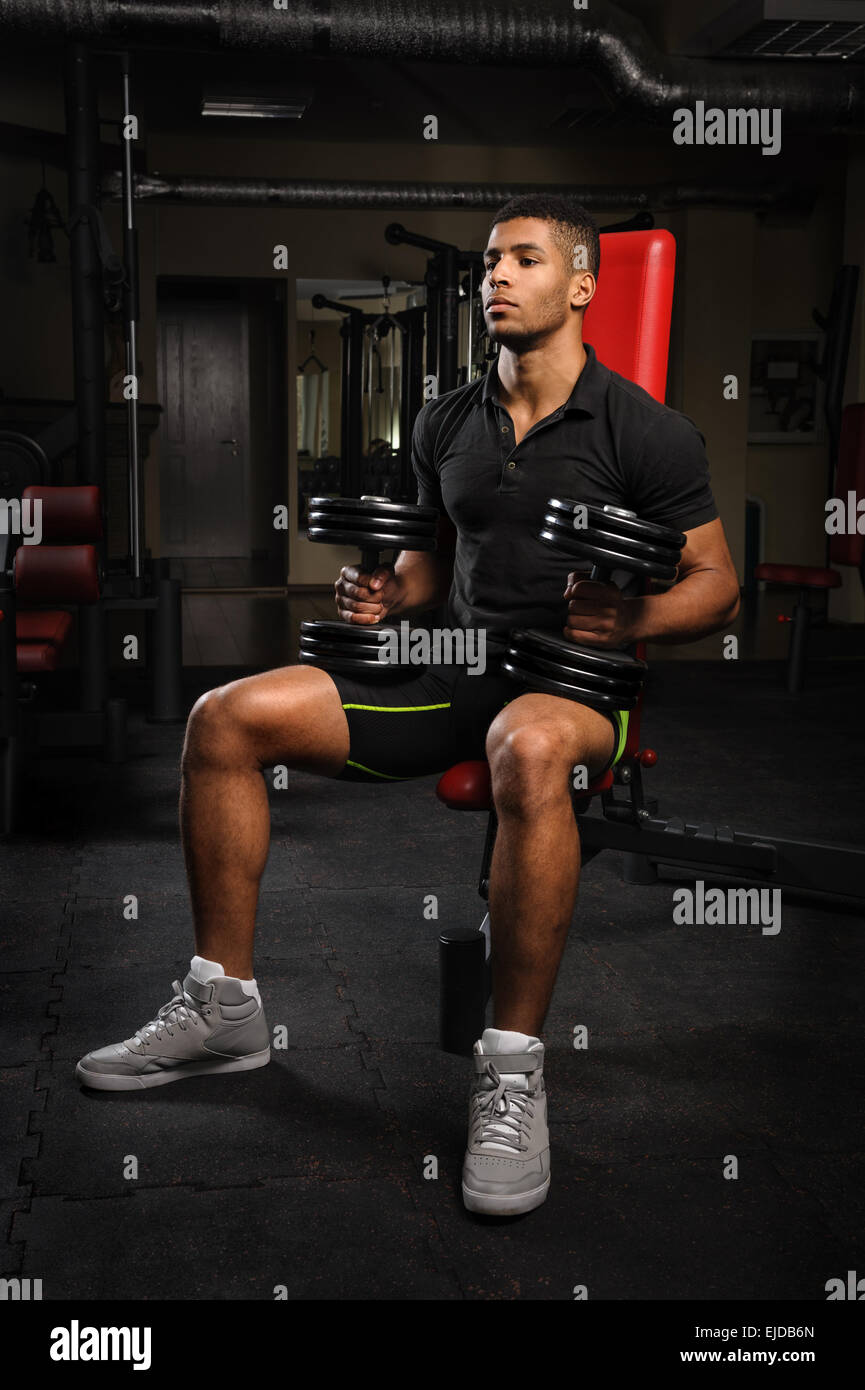 young man sitting on bench at gym Stock Photo - Alamy