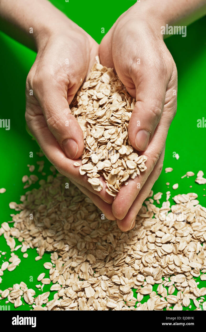 Oats in a handful Stock Photo - Alamy