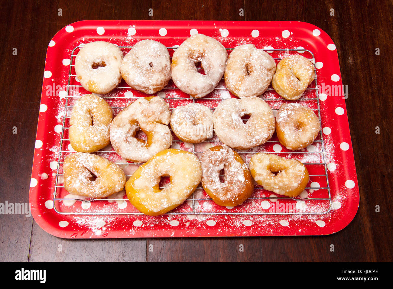 Fresh home made donuts cooling on a rack Stock Photo - Alamy