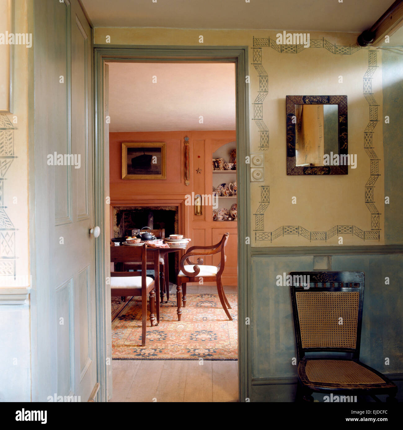 Stenciled walls in country hall with painted dado paneling and door ...