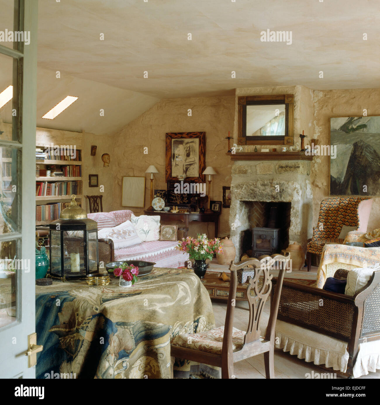 Patterned cloth on dining table in cluttered nineties cottage sitting ...