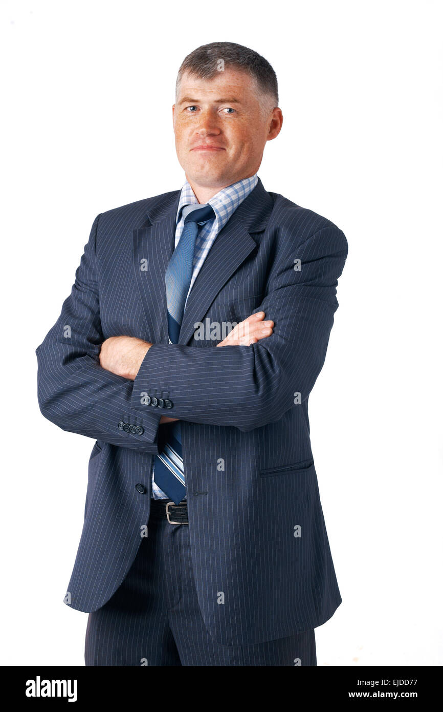 Portrait of mature business man with folded hands against white ...