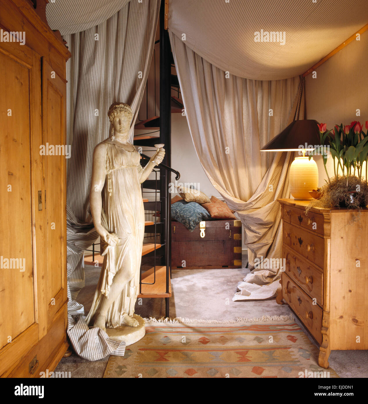 Classical marble statue in eighties hall with heavy cream drapes on ...