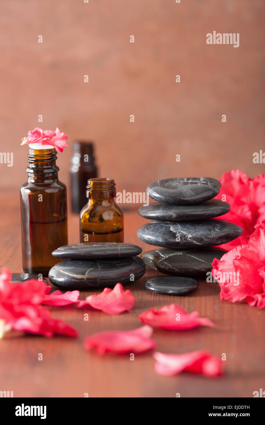 essential oil azalea flowers black massage stones Stock Photo - Alamy