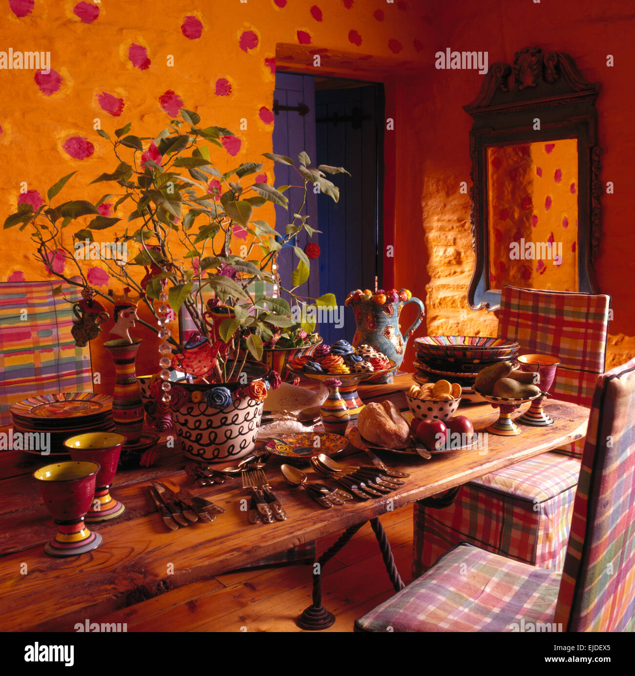 Mary-Rose Young pottery on a wooden table in colorful nineties dining ...