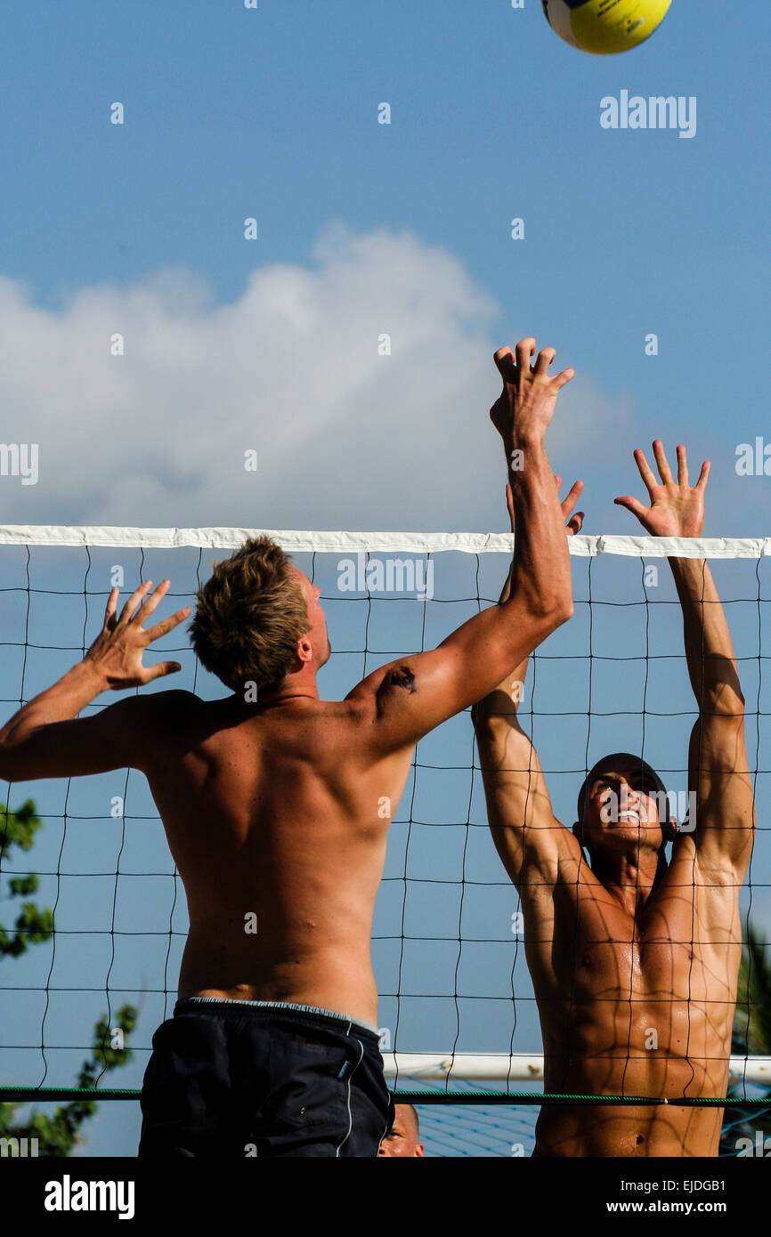 Kuta beach, Bali, Indonesia. European tourists play volleyball on the ...