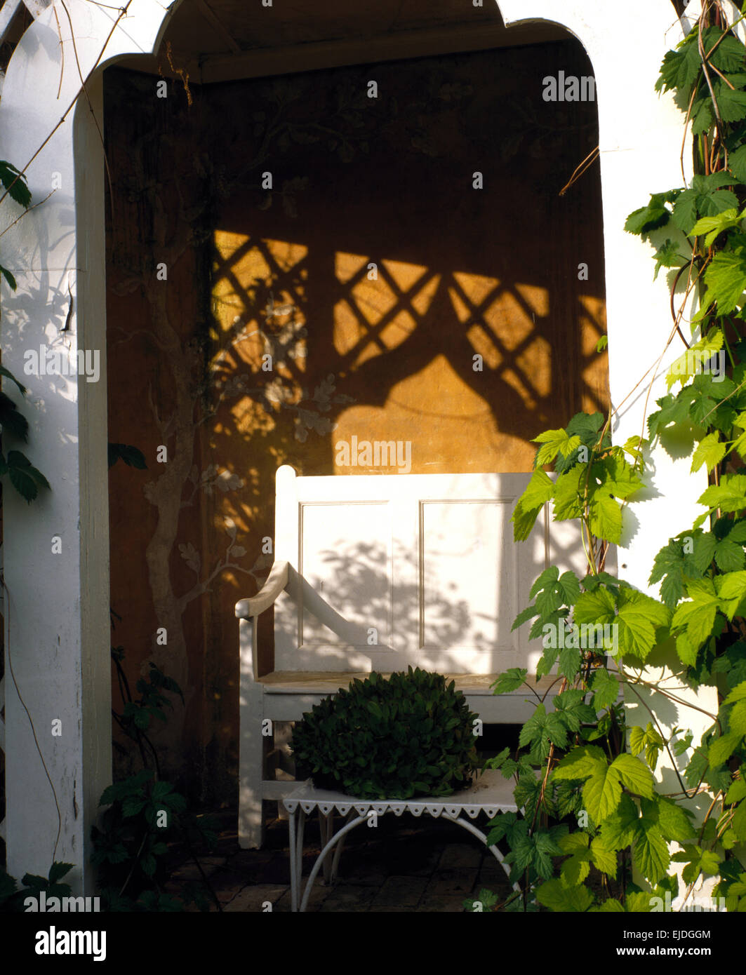 White bench in white painted wooden arbour in country garden Stock ...