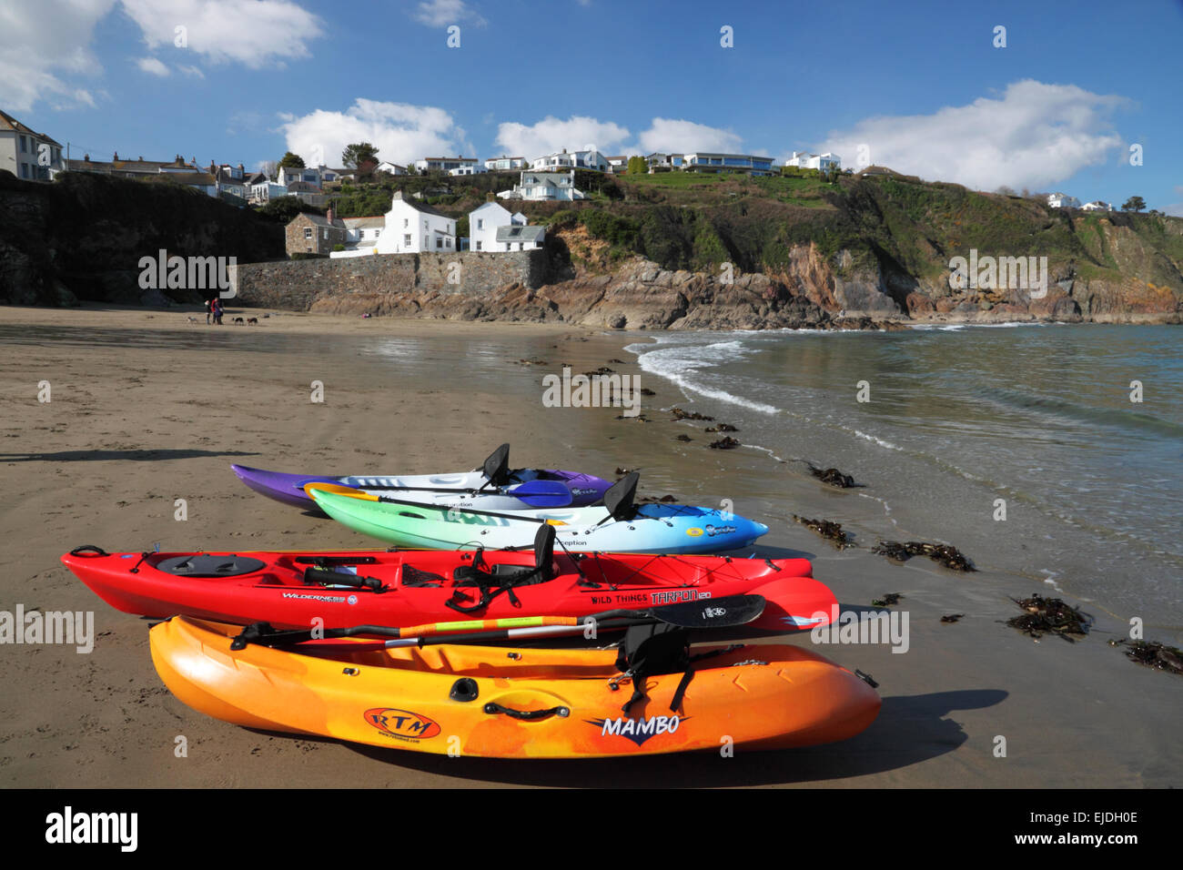 Yellow and red kayaks on a sandy Cornish beach Stock Photo - Alamy