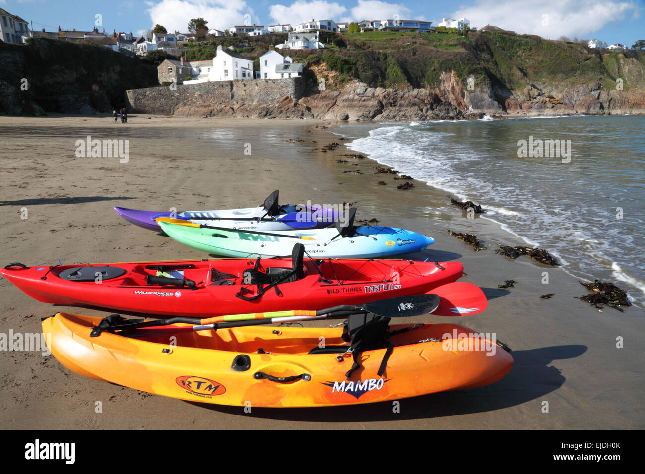Yellow and red kayaks on a sandy Cornish beach Stock Photo - Alamy