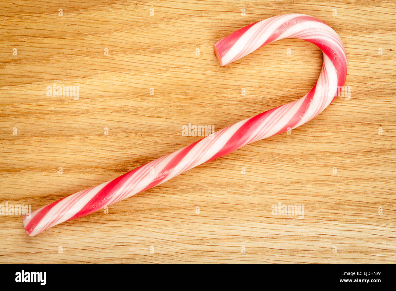 Christmas candy cane on wood texture Stock Photo - Alamy
