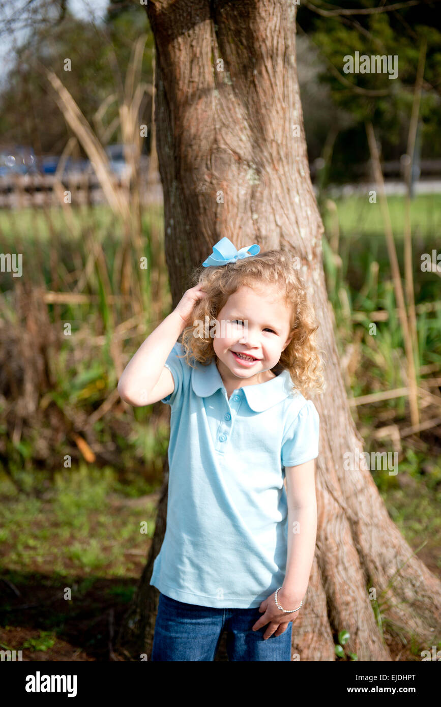 Kid leaning against tree hi-res stock photography and images - Alamy