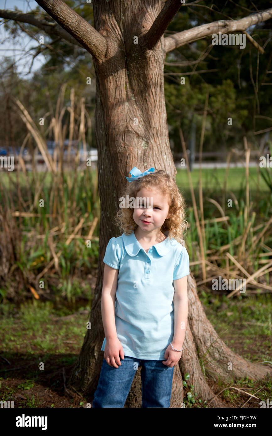 Kid leaning against tree hi-res stock photography and images - Alamy